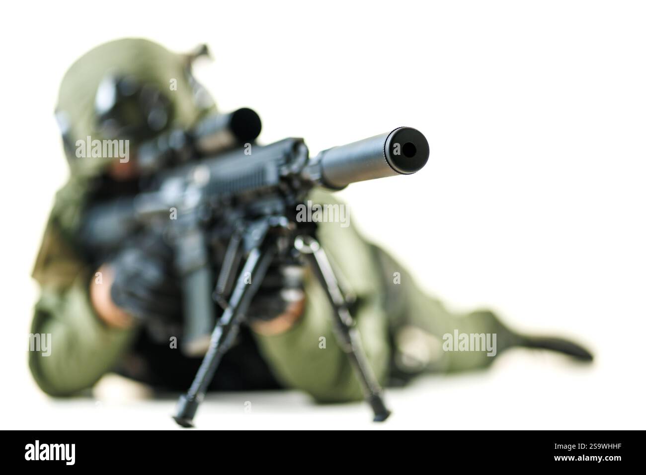 A soldier in camouflage uniform targets with precision through a rifle ...
