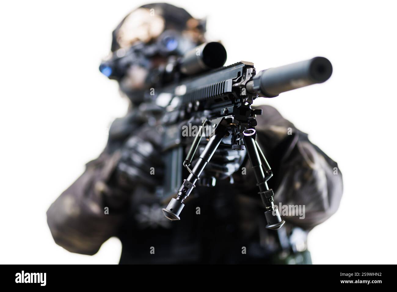 A tactical operator dressed in full combat gear, aiming with a ...