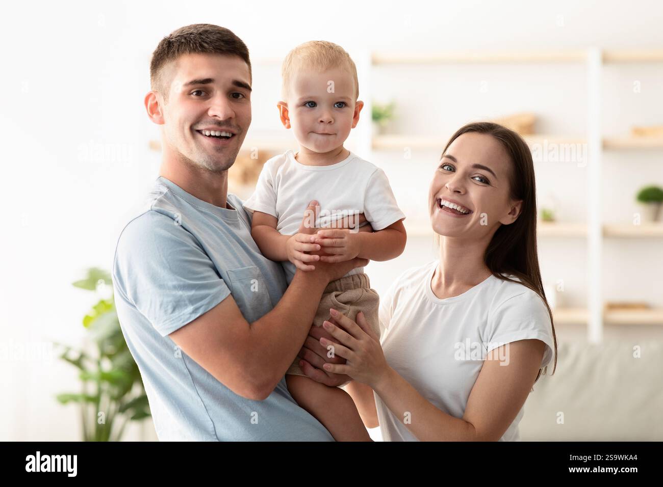 Family Care. Portrait Of Happy Young Parents And Their Cute Infant ...