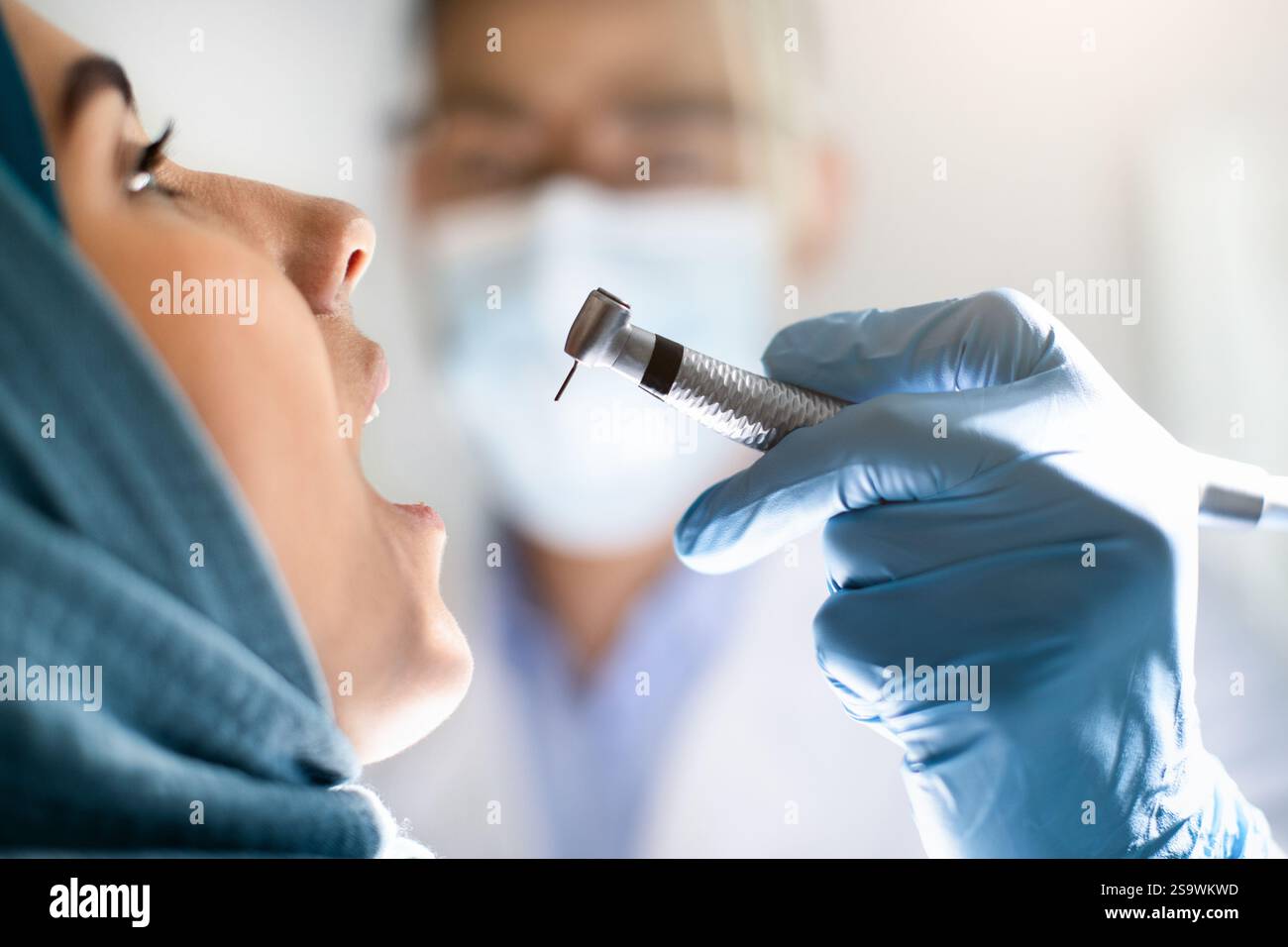 Closeup Of Arab Dentist Using Dental Drill For Muslim Woman Patient ...