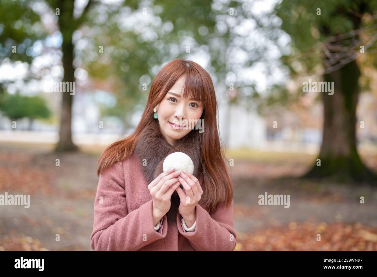A park with beautiful autumn leaves. Japanese women with long hair in ...