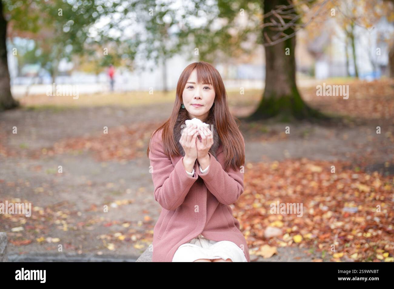 A park with beautiful autumn leaves. Japanese women with long hair in ...