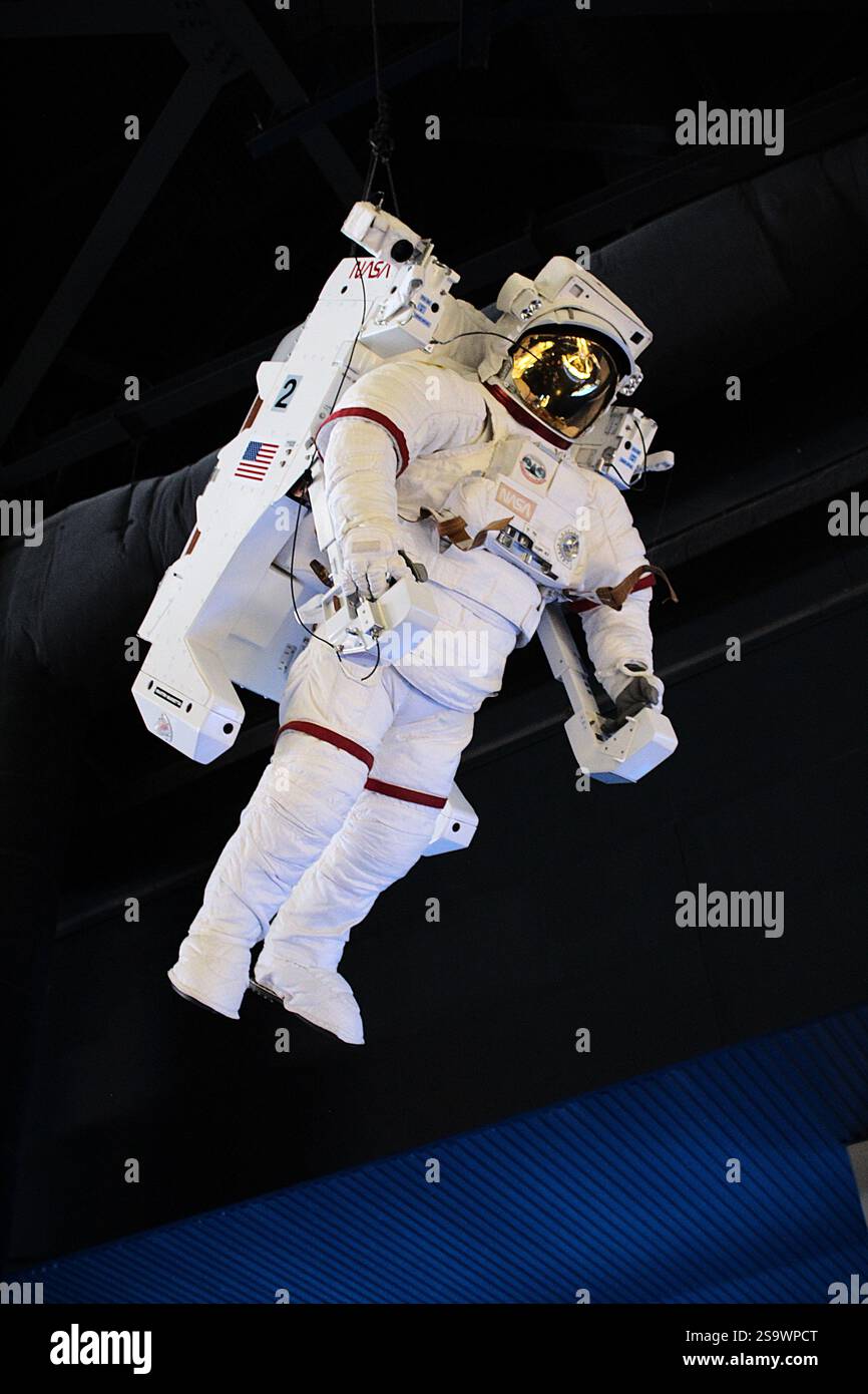 An astronaut suit with a golden face shield hangs high above the ground ...