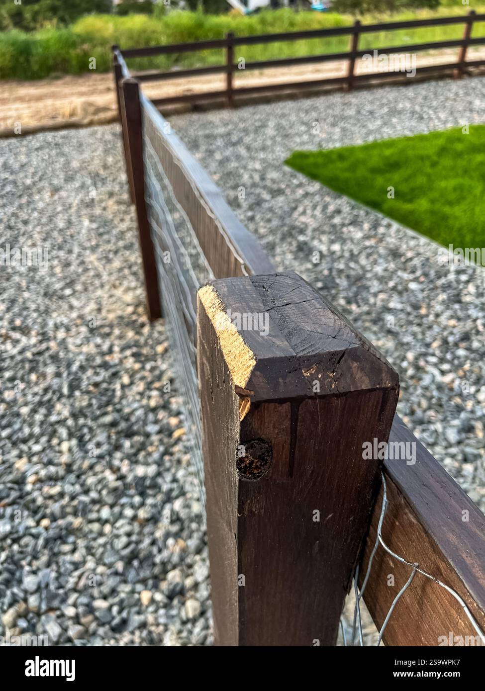 Split rail fence installation with wire mesh Stock Photo - Alamy