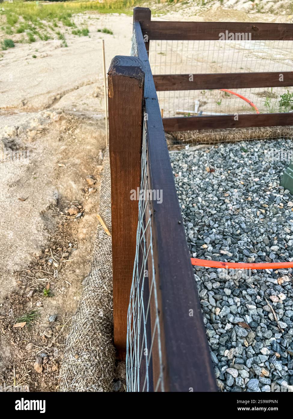 Split rail fence installation with wire mesh Stock Photo - Alamy