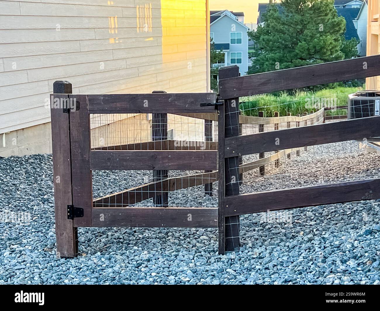 Split rail fence installation with wire mesh Stock Photo - Alamy