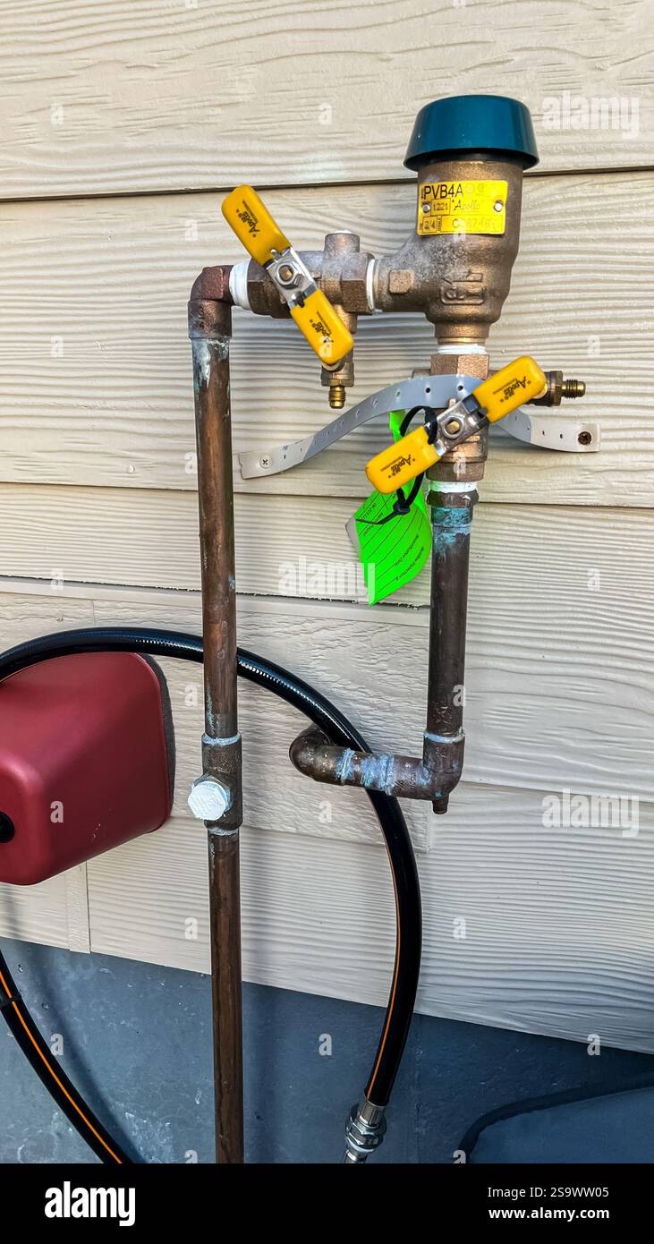 Residential irrigation system backflow preventer outdoors Stock Photo ...
