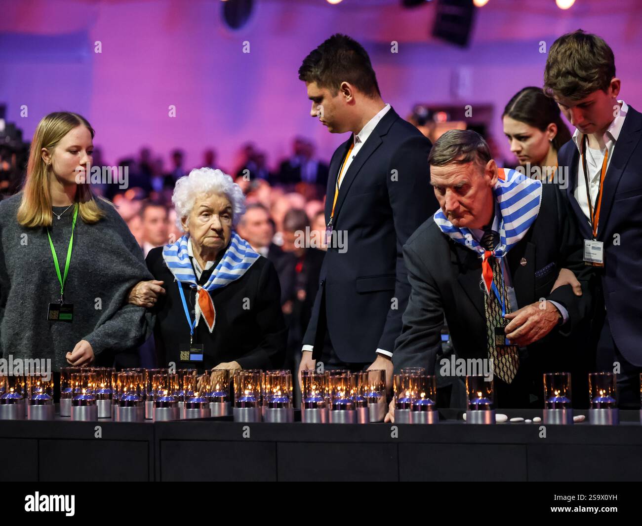 Camp survivors and their close carers leave candles by a symbolic Nazi ...