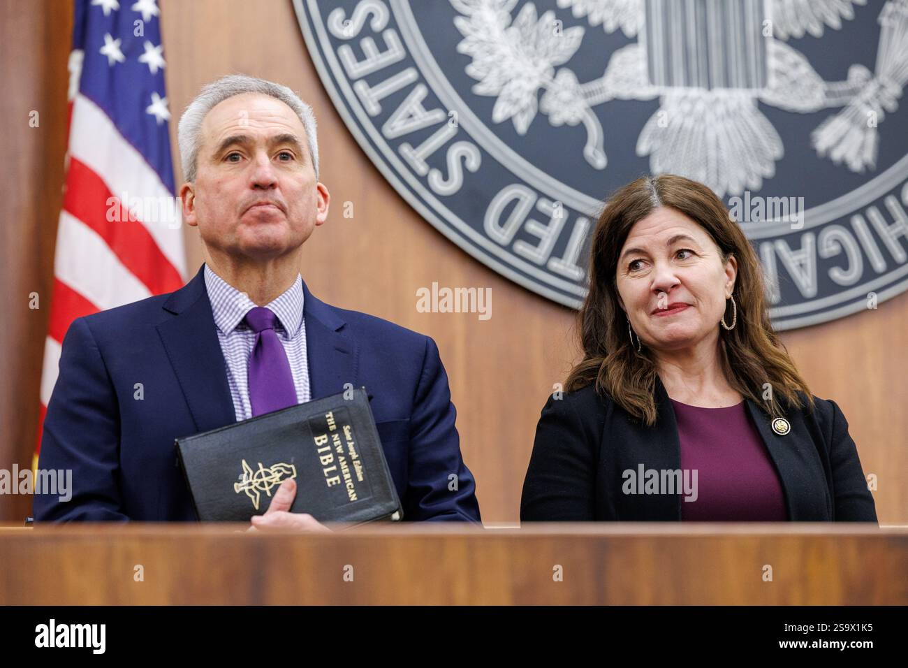 Flint, USA. 27th Jan, 2025. Bay City Commissioner Joseph Rivet, left ...