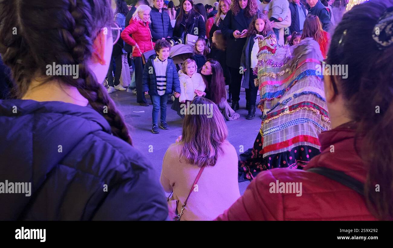 A street performer entertains young children surrounded by a crowd on ...