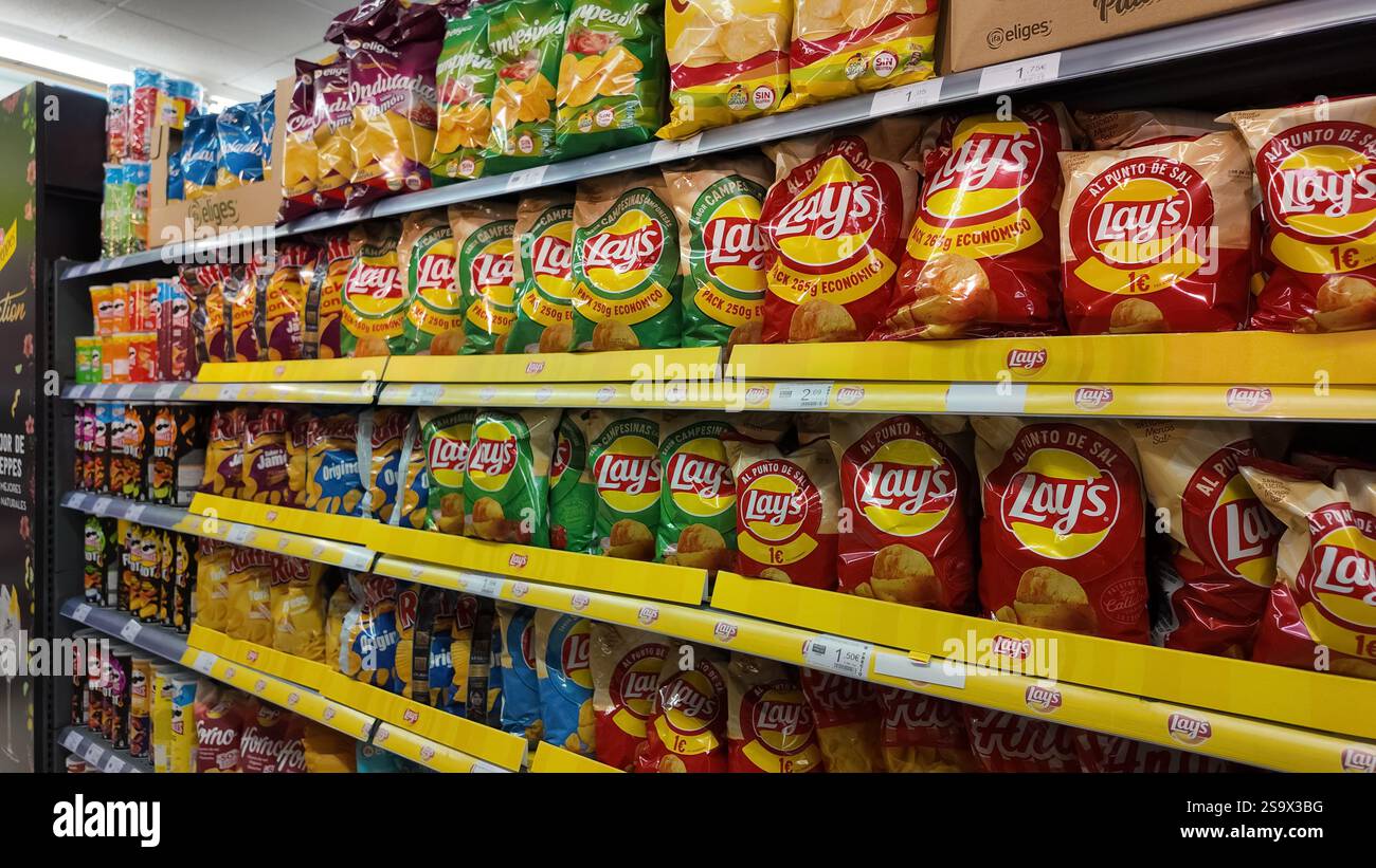 Supermarket shelves in Spain are fully stocked with potato chips and ...