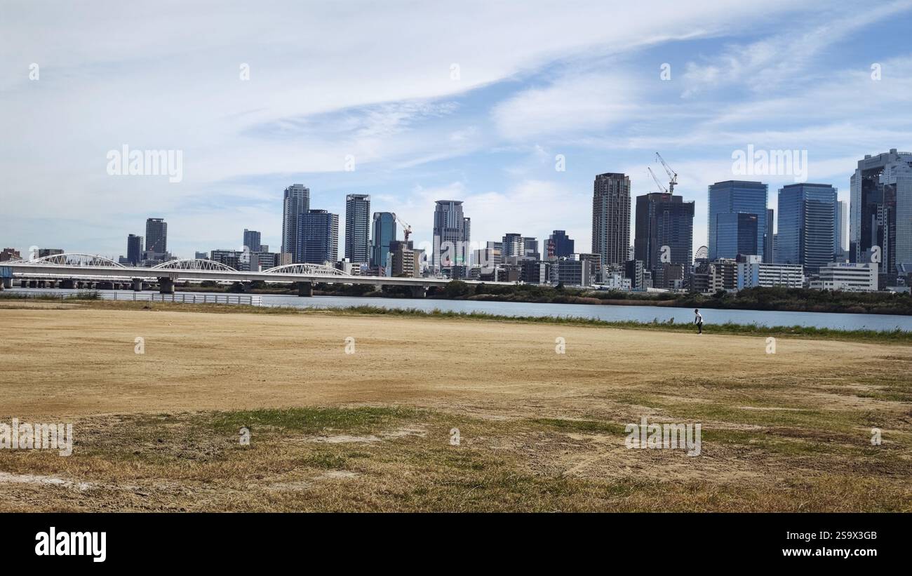 Baseball field near Yodo river with bridge and skyline of Umeda in ...