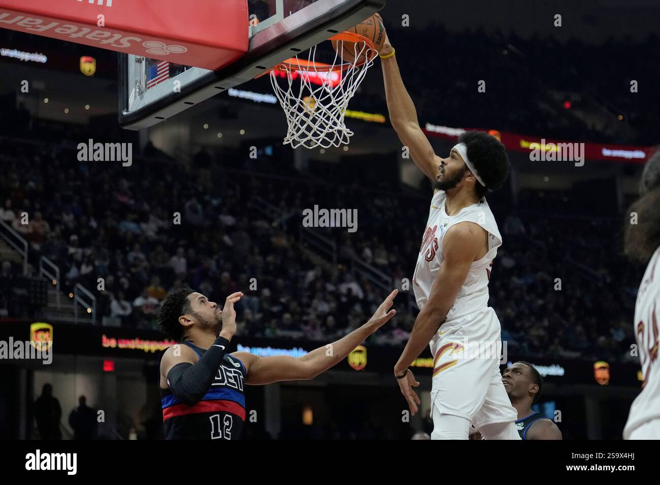 Cleveland Cavaliers center Jarrett Allen, right, dunks in front of ...