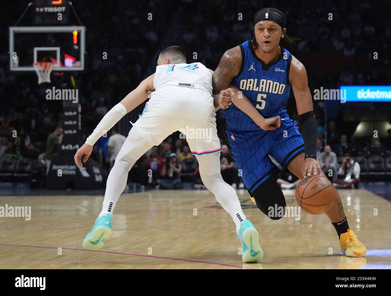 Orlando Magic forward Paolo Banchero (5) dribbles as Miami Heat guard ...