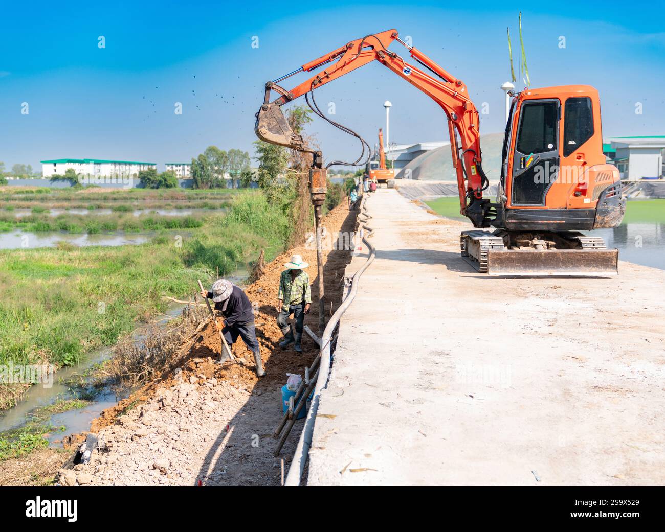 The workers are clearing the area around the hole that the small ...