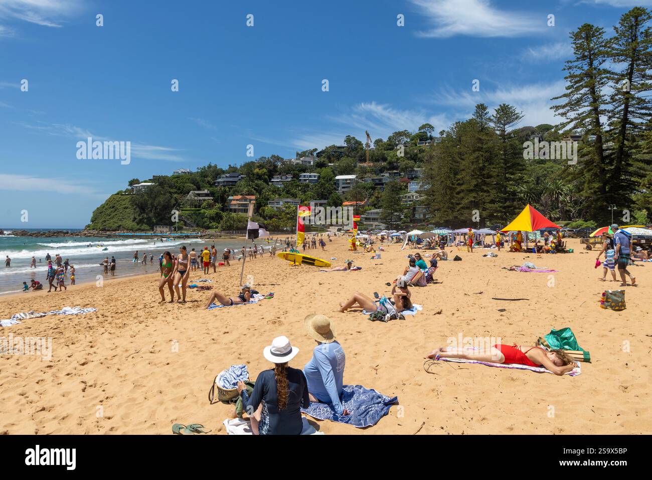 People enjoy a relaxing summers day on the sand sunbathing and swimming ...
