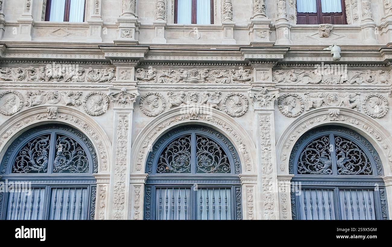 The facade of Ayuntamiento de Sevilla or Seville city hall features ...
