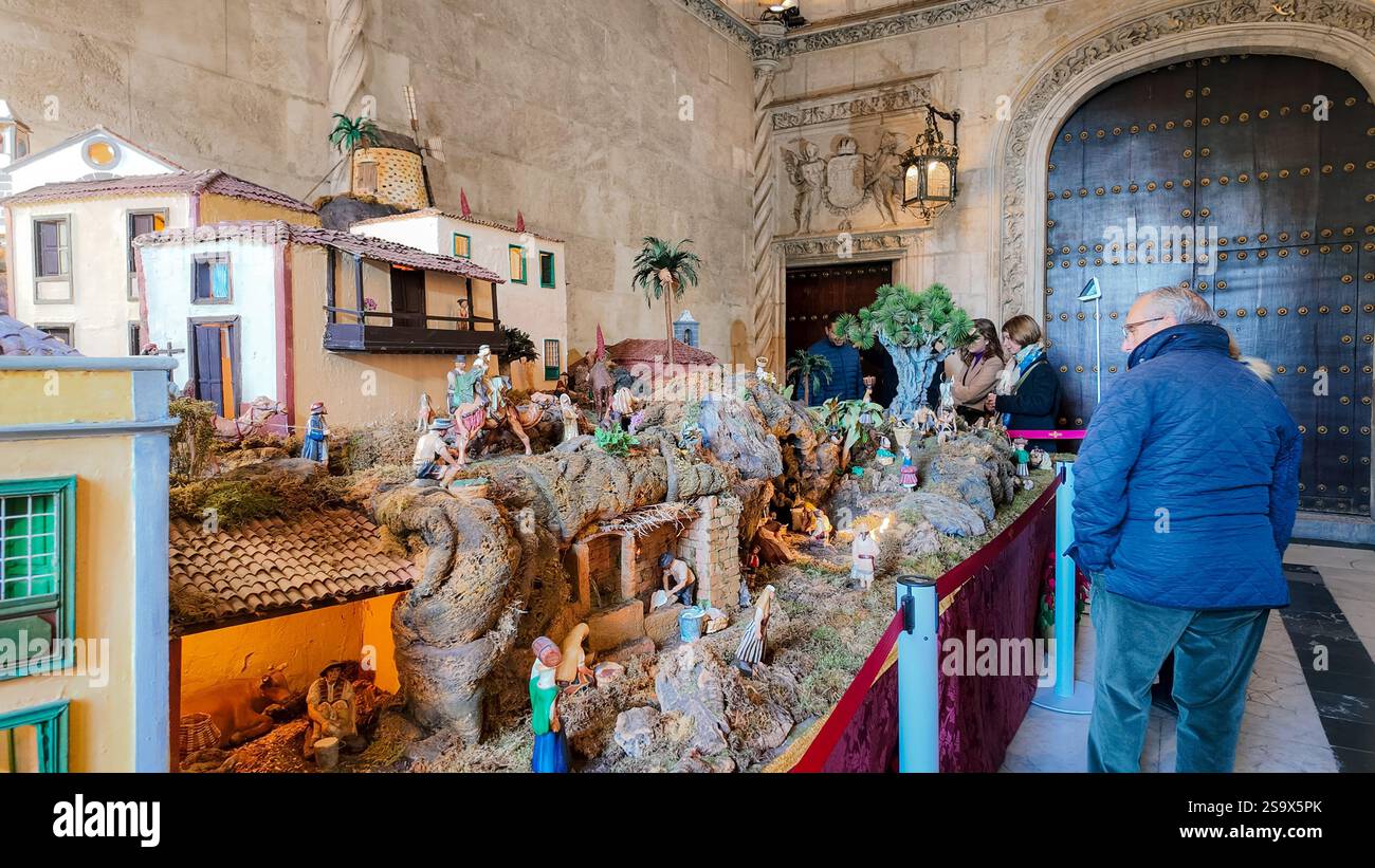 Visitors exploring indoor Nativity scenes, known as Belenes, in Seville ...