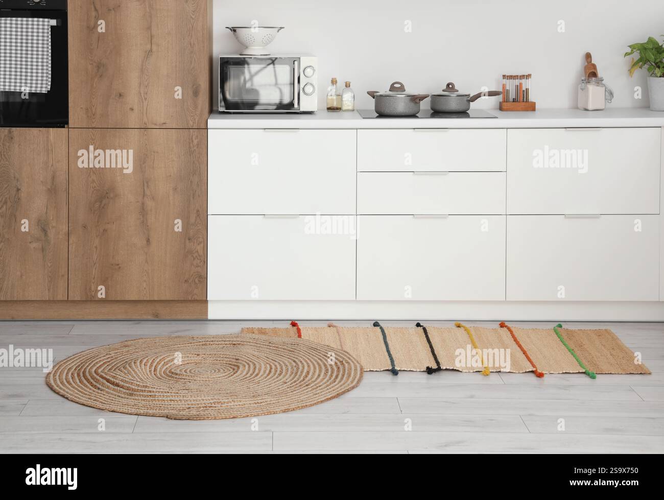 Interior of light kitchen with counters and carpets Stock Photo - Alamy