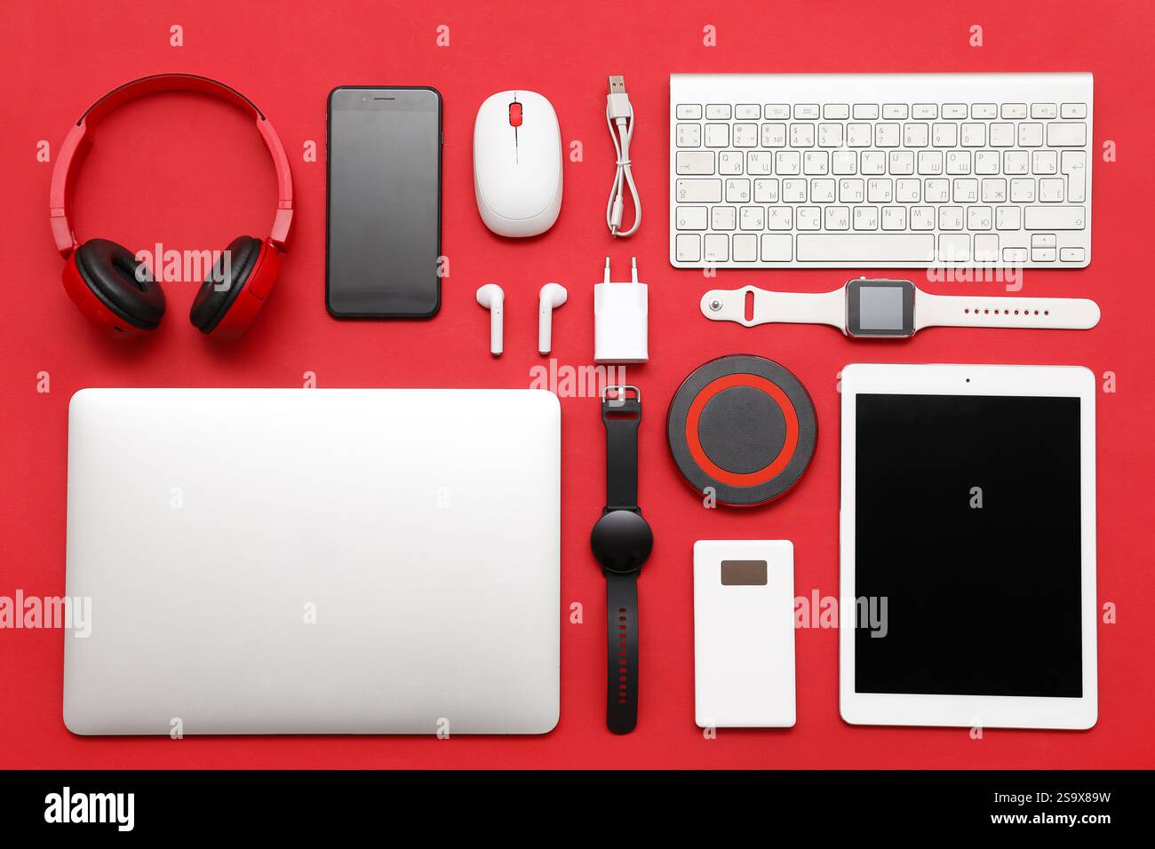 Set of modern devices on red background, top view Stock Photo - Alamy