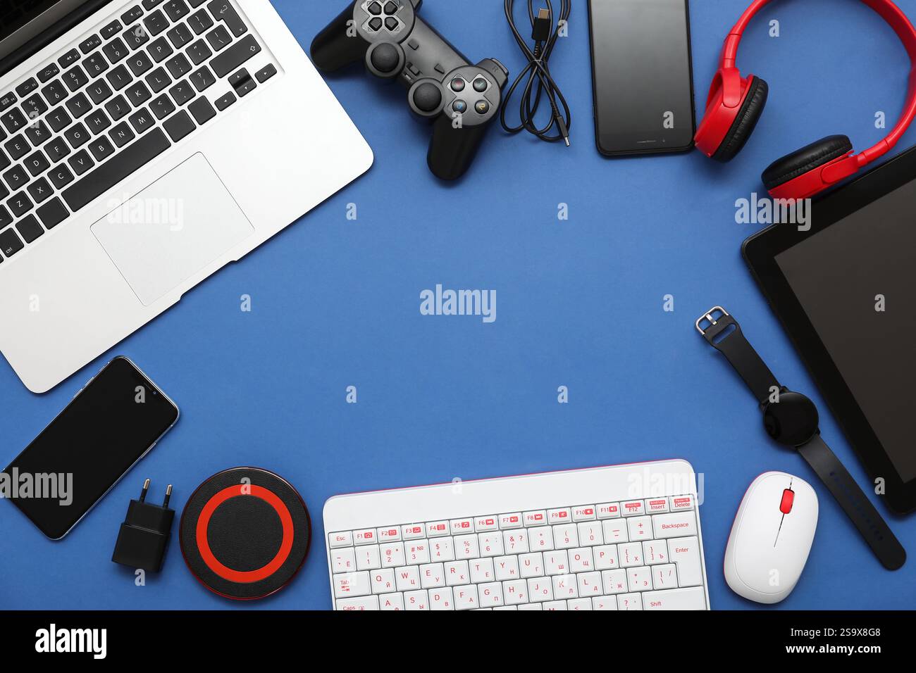 Frame made of different modern gadgets on blue background Stock Photo ...