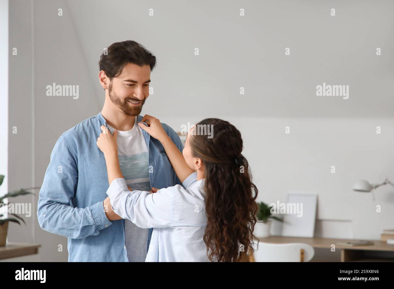 Beautiful loving woman adjusting shirt hi-res stock photography and ...