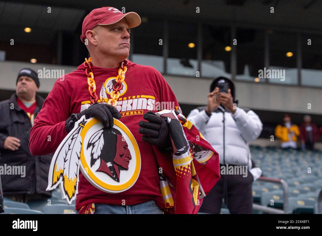 Washington Commanders fan holding up a "Redskins" logo during warm-ups ...