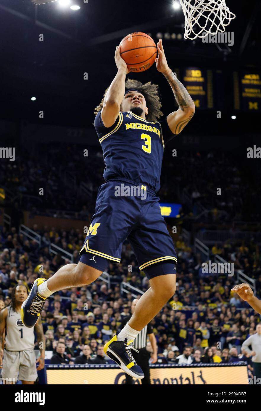 Michigan guard Tre Donaldson (3) goes to the basket against Penn State ...