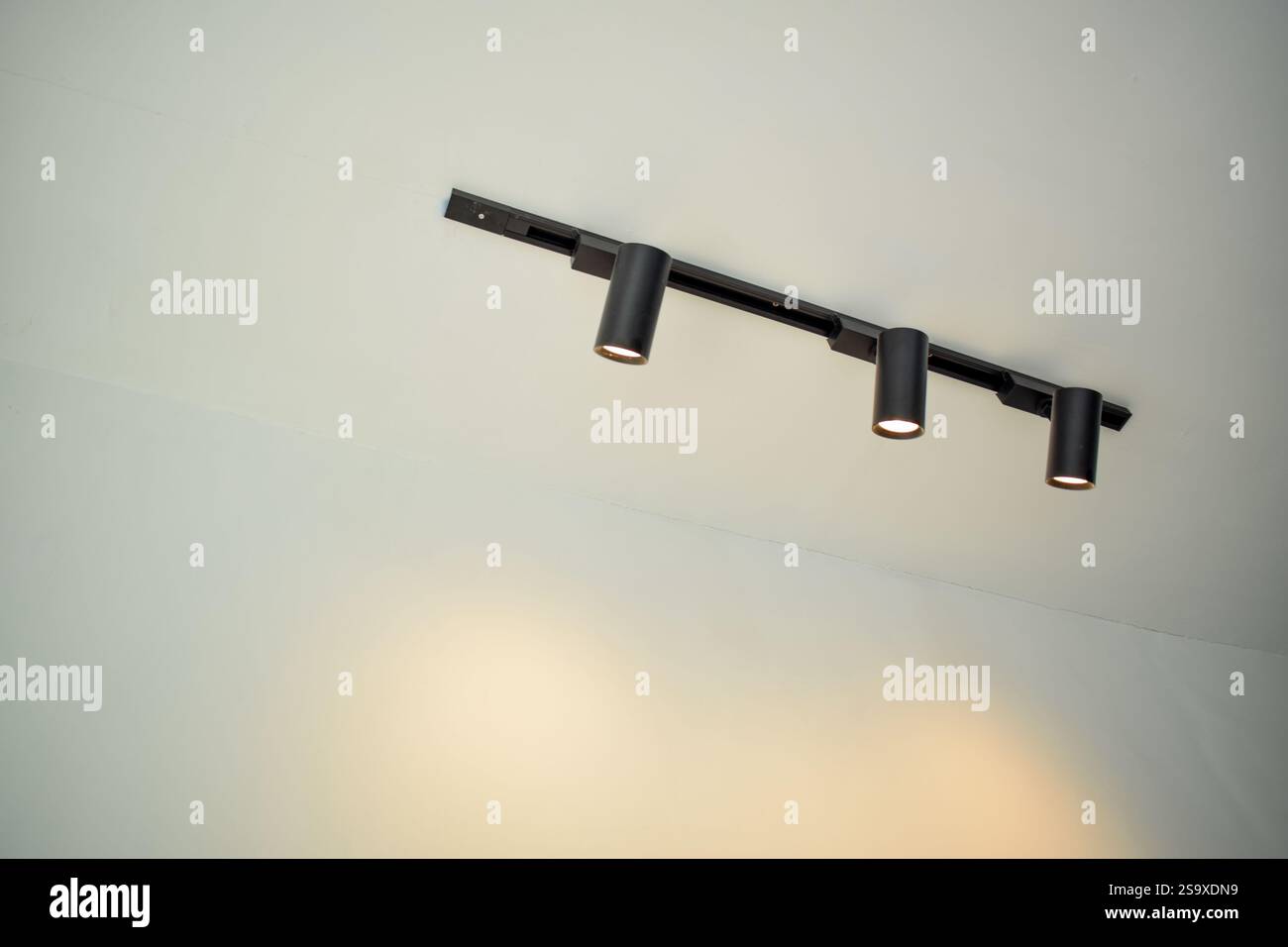 Spotlights under the ceiling on the wall. LED track lighting system ...