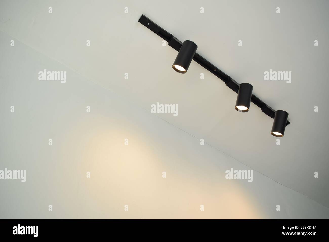 Spotlights under the ceiling on the wall. LED track lighting system ...