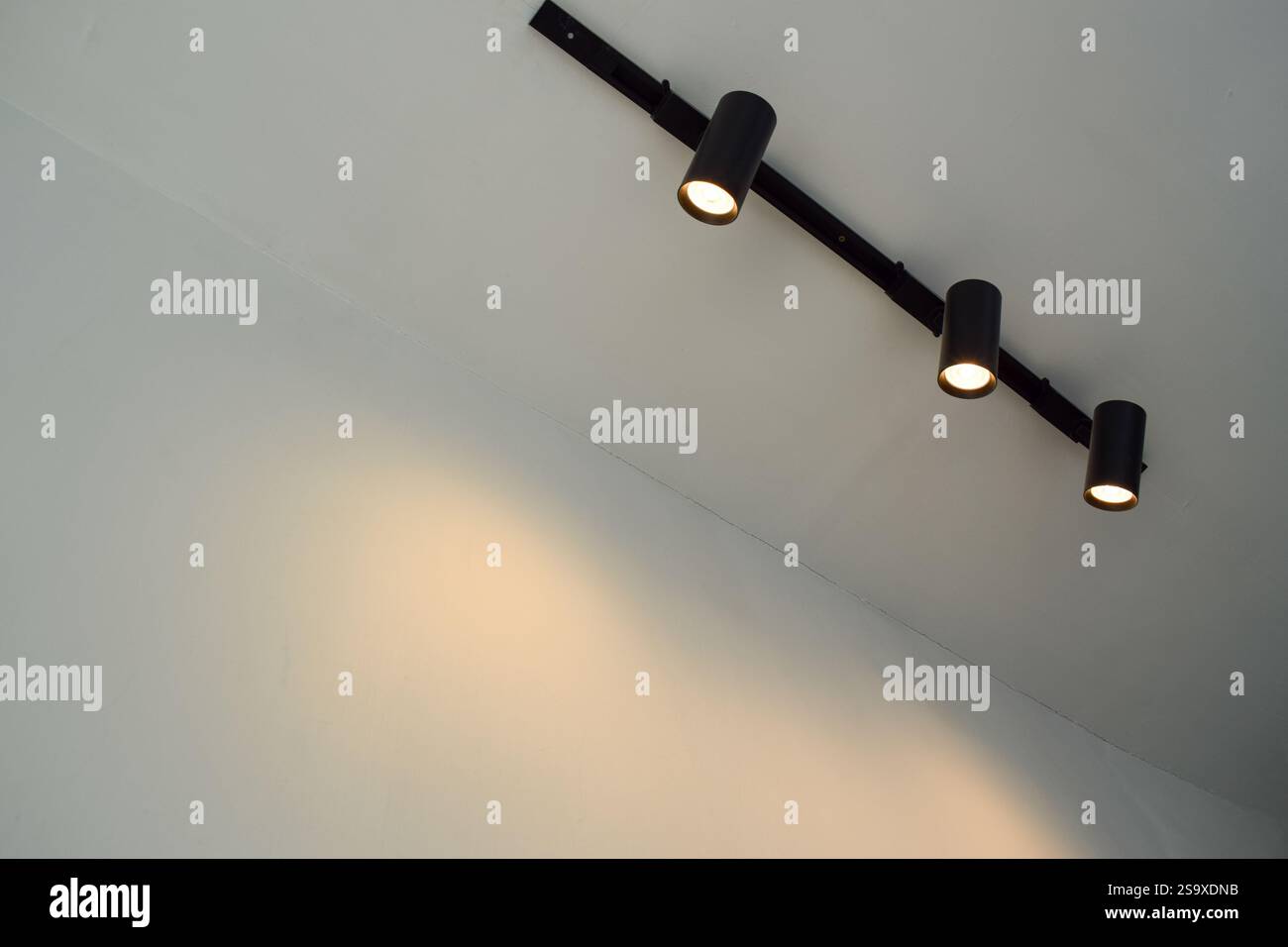 Spotlights under the ceiling on the wall. LED track lighting system ...