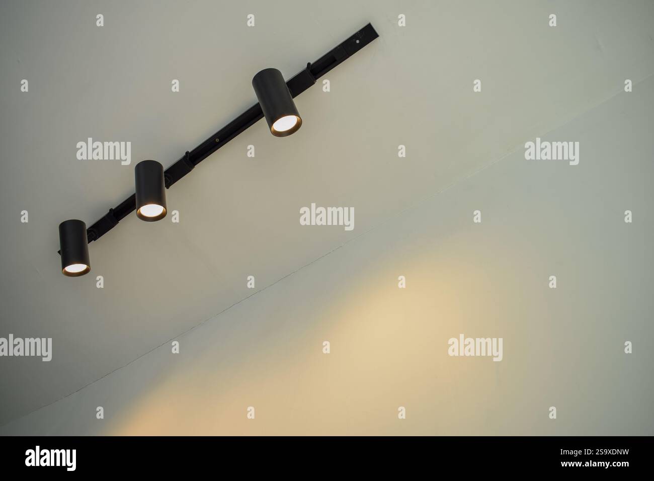 Spotlights under the ceiling on the wall. LED track lighting system ...