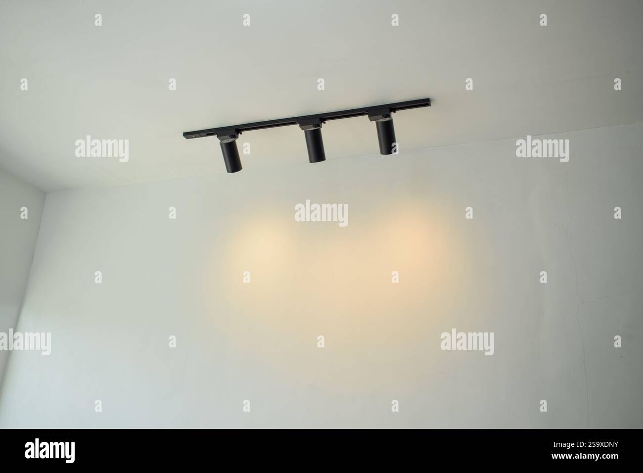 Spotlights under the ceiling on the wall. LED track lighting system ...