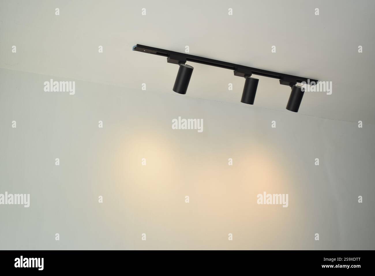Spotlights under the ceiling on the wall. LED track lighting system ...