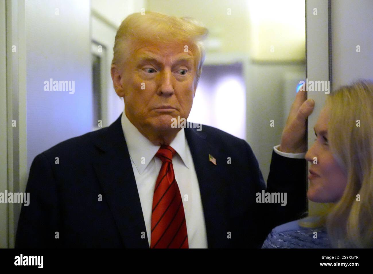 President Donald Trump speaks to reporters aboard Air Force One en ...