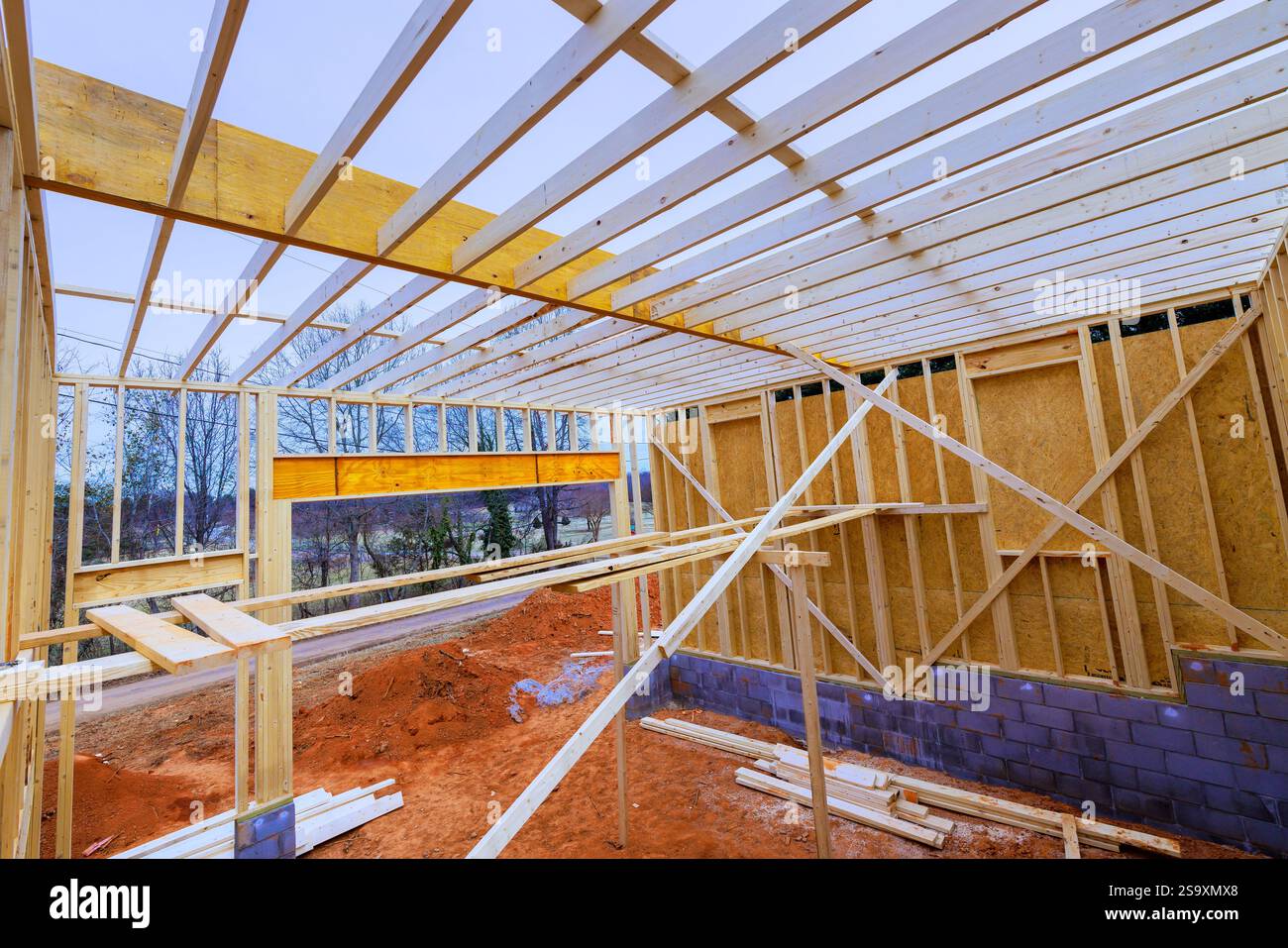 Construction are building wooden beams frame in rural setting, under ...