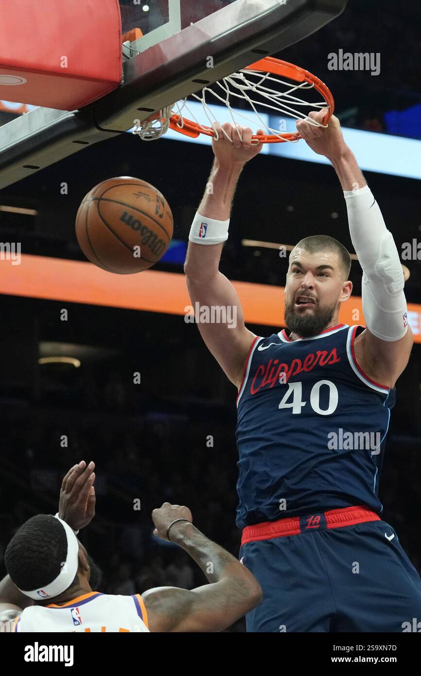 Los Angeles Clippers center Ivica Zubac (40) hangs from the rim after ...