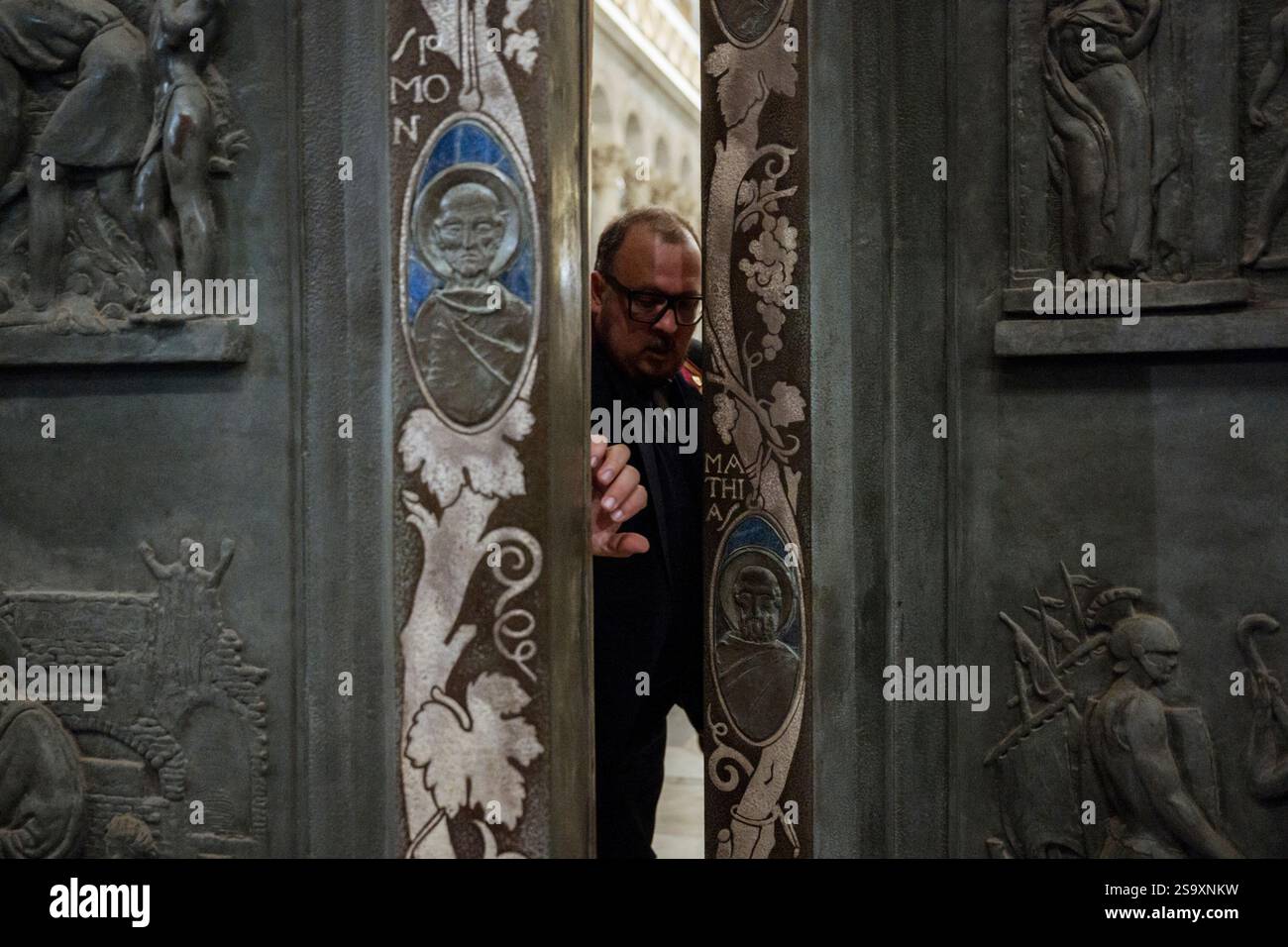 Rome, Italy. 25th Jan, 2025. A gatekeeper closes the holy door of St ...