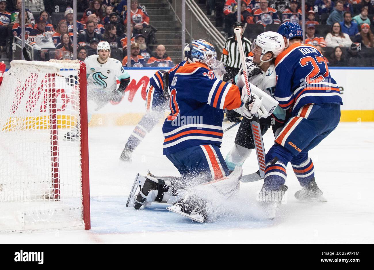Seattle Kraken's John Hayden, center, and Edmonton Oilers' Brett Kulak ...