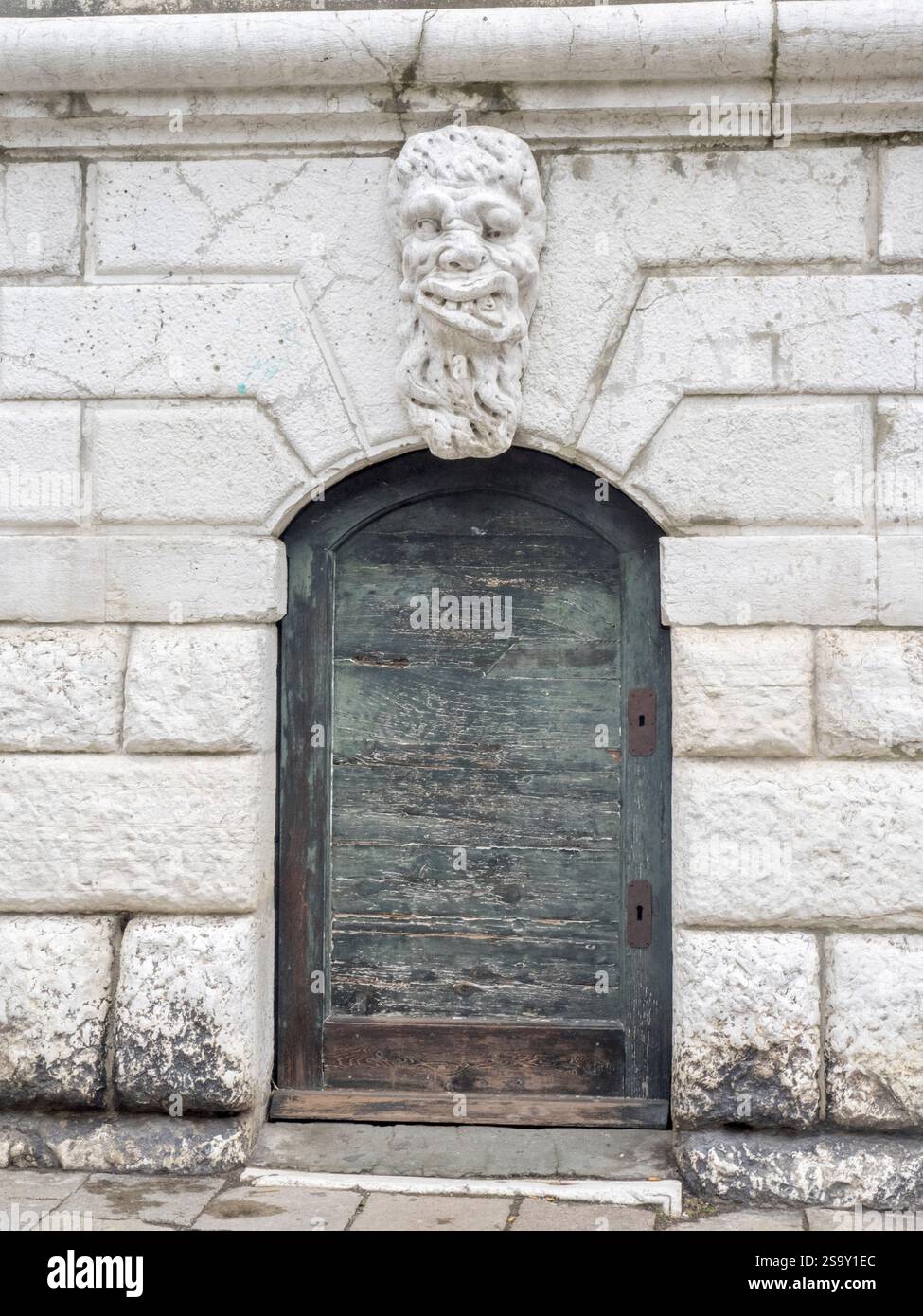 Italy, Venice. Grotesque stone carving of a male gargoyle figure on ...