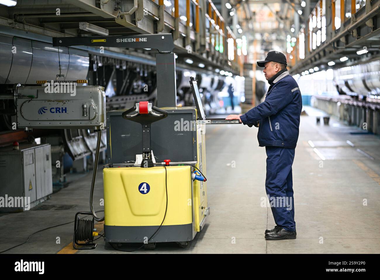 NANJING, CHINA - JANUARY 28, 2025 - A worker inspects a train at the ...