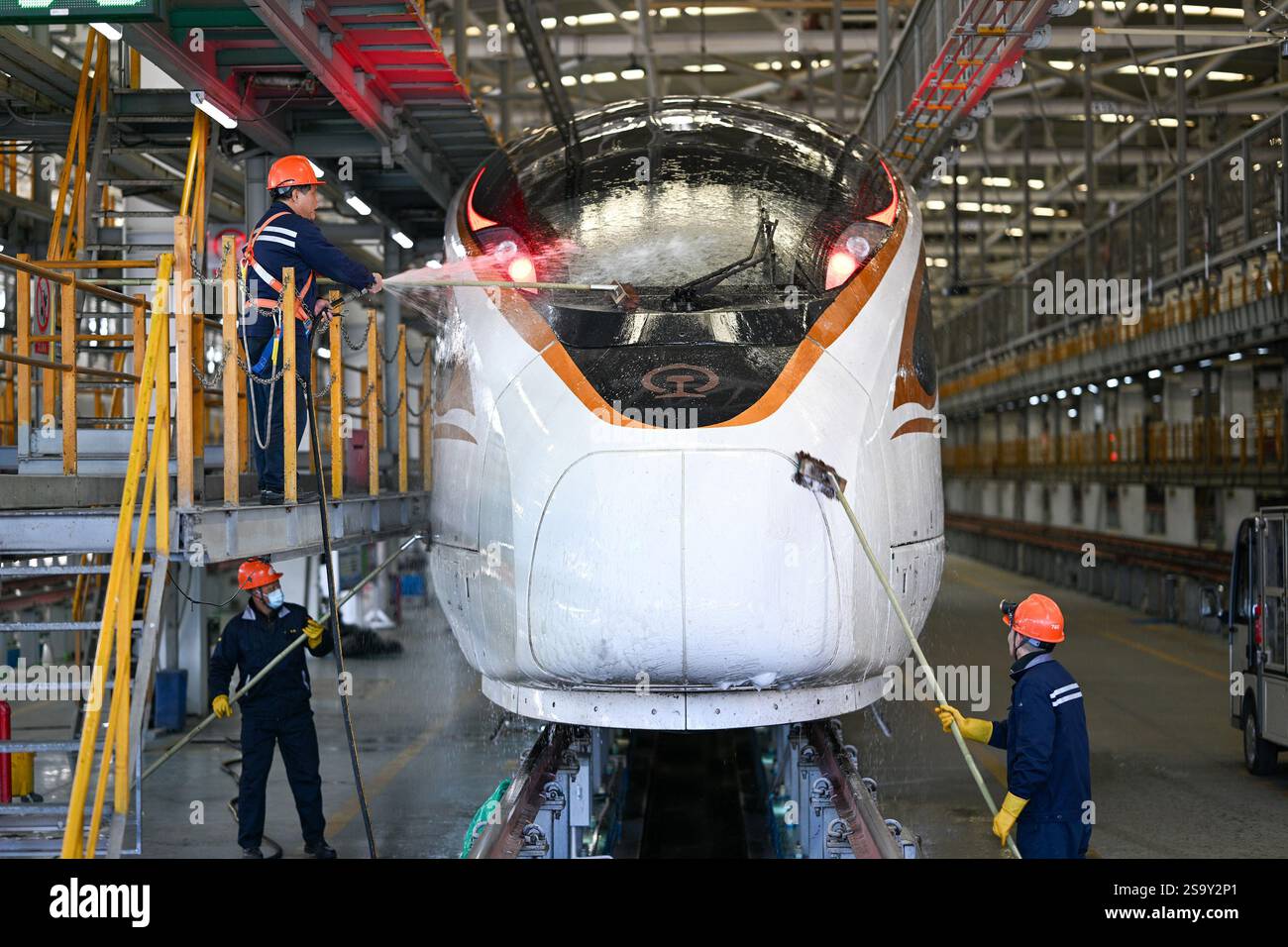 NANJING, CHINA - JANUARY 28, 2025 - Workers clean a train in the ...