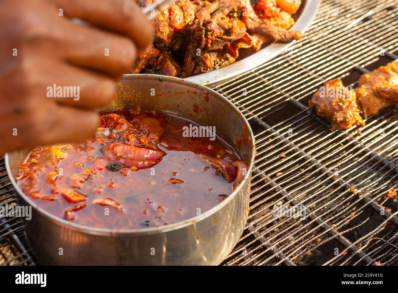 street food bbq with pork and plantains grilling over open flame ...