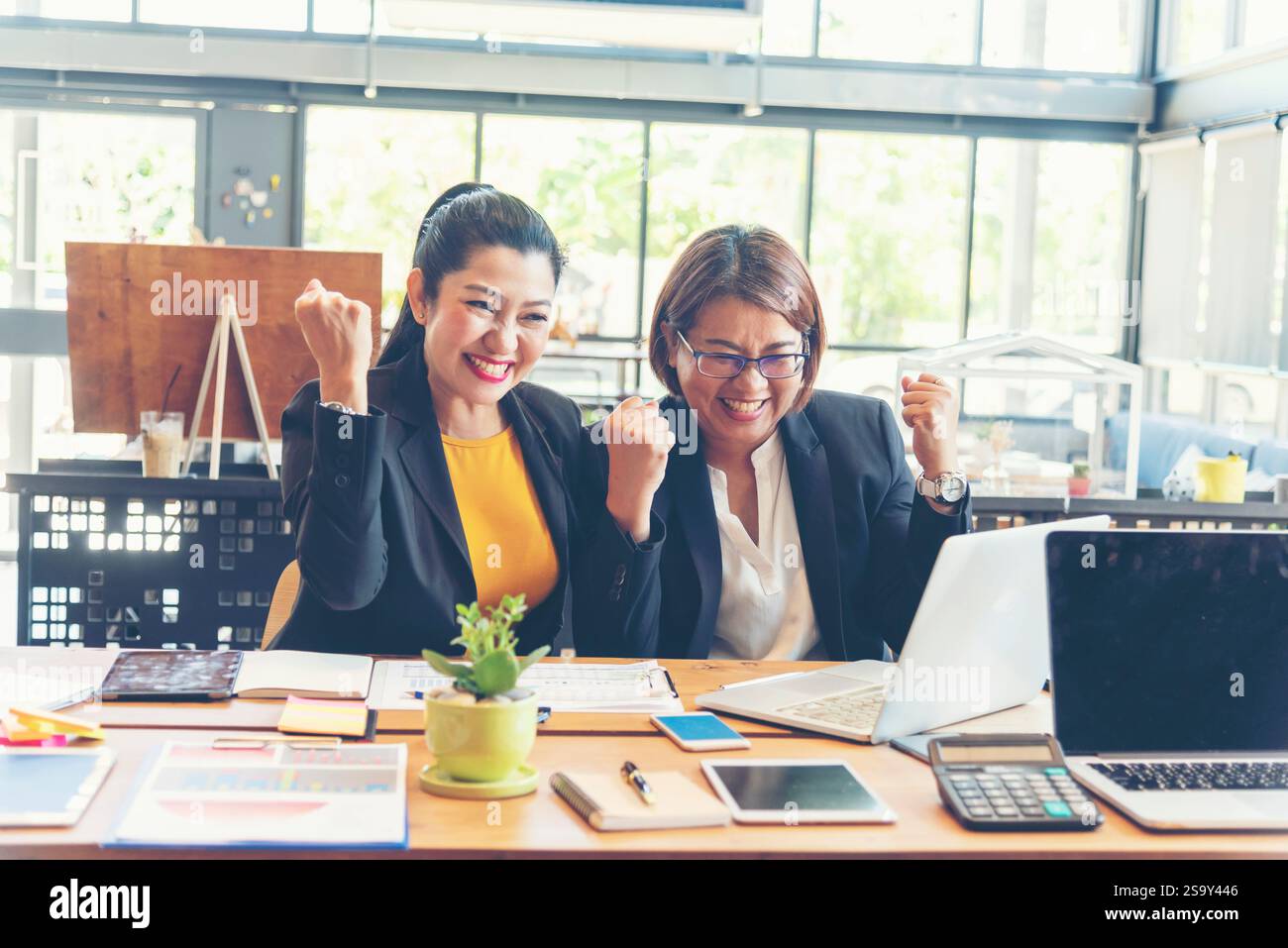 Happy success business woman partner working together in company office ...