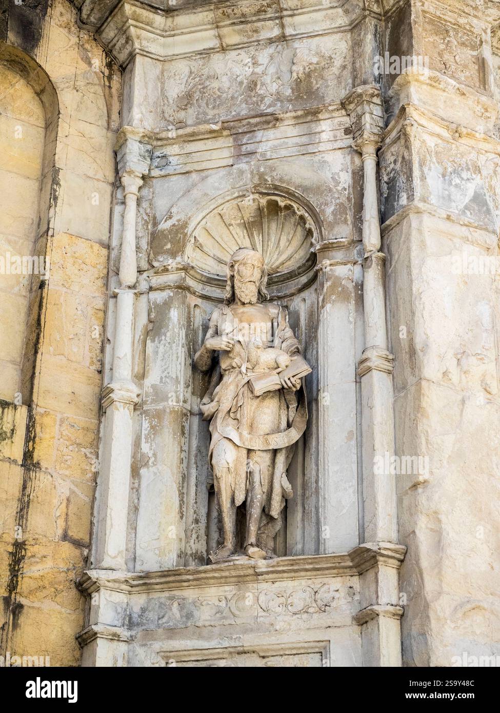 Carved statue of St. John the Baptist on the Old Cathedral of Coimbra ...