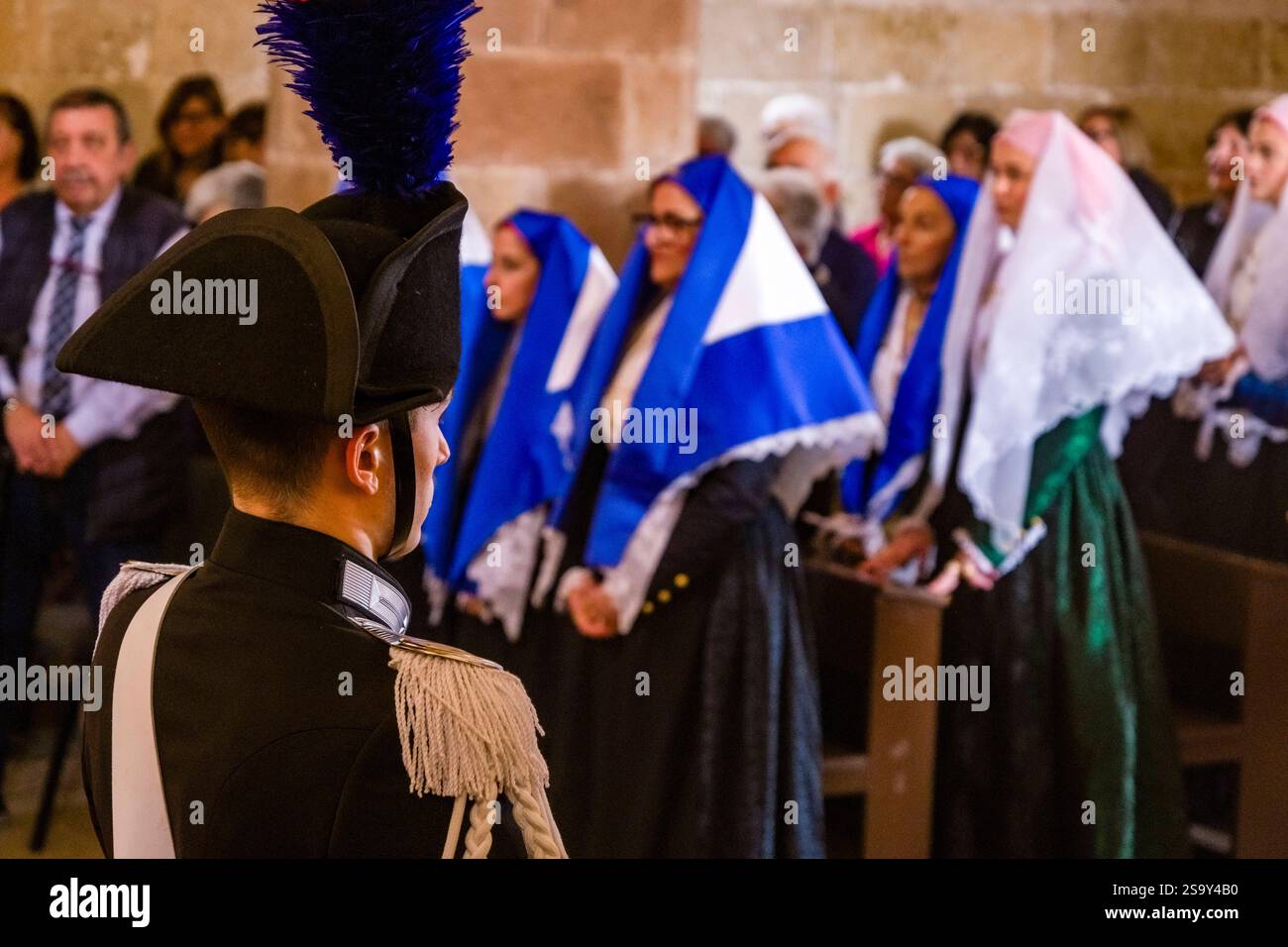 Traditionally dressed people in the church of Santa Maria di Montserrat ...