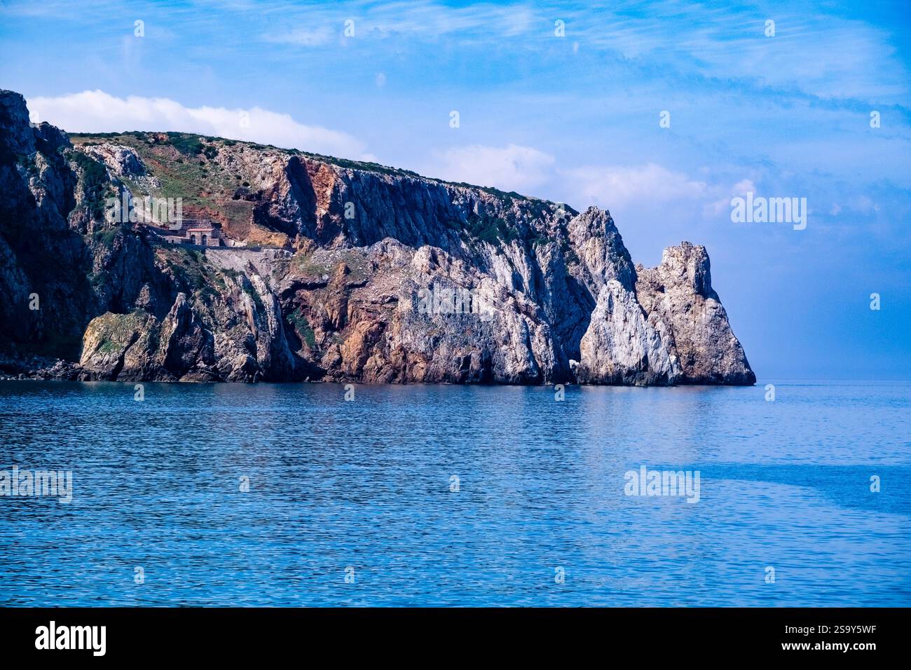 Rugged coastline and destroyed factory building of the former mining ...
