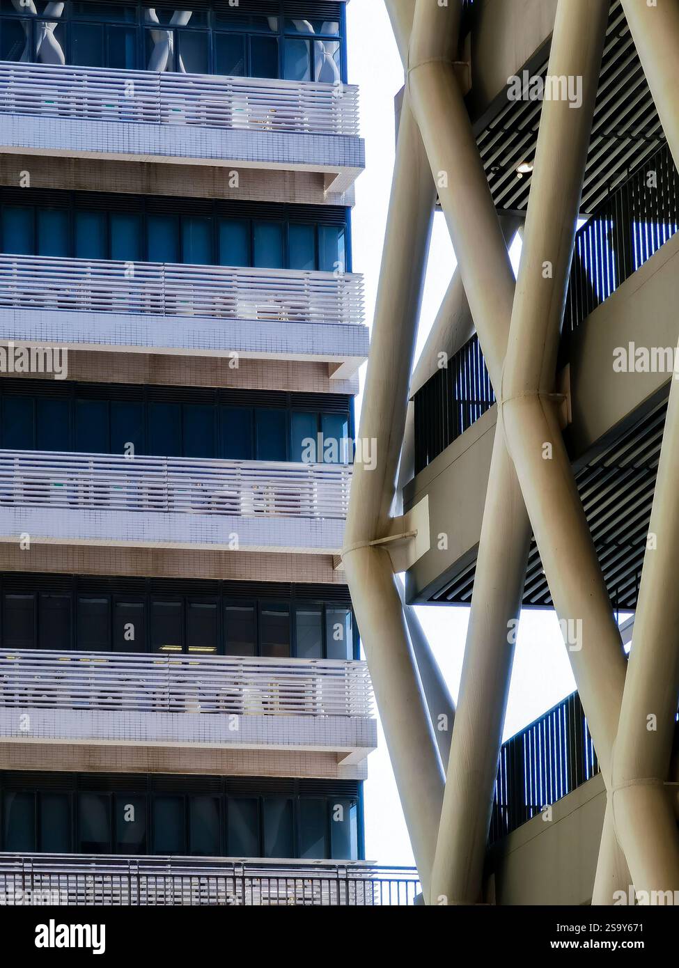 Close-up details of two Hong Kong buildings. One shows layered balconies, the other, an ...