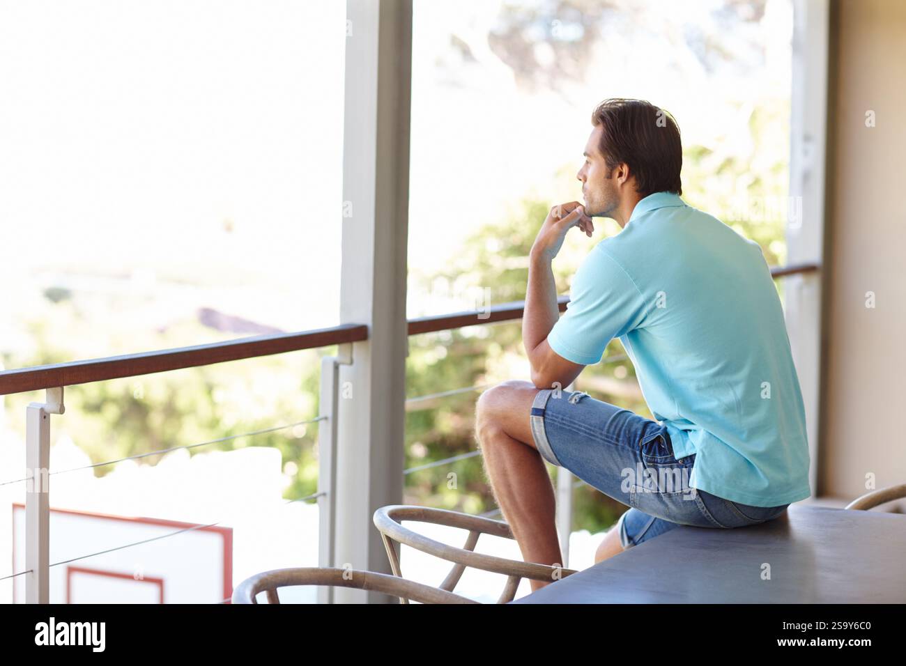 Home, thinking and man with thoughts in balcony, sitting and nostalgic ...