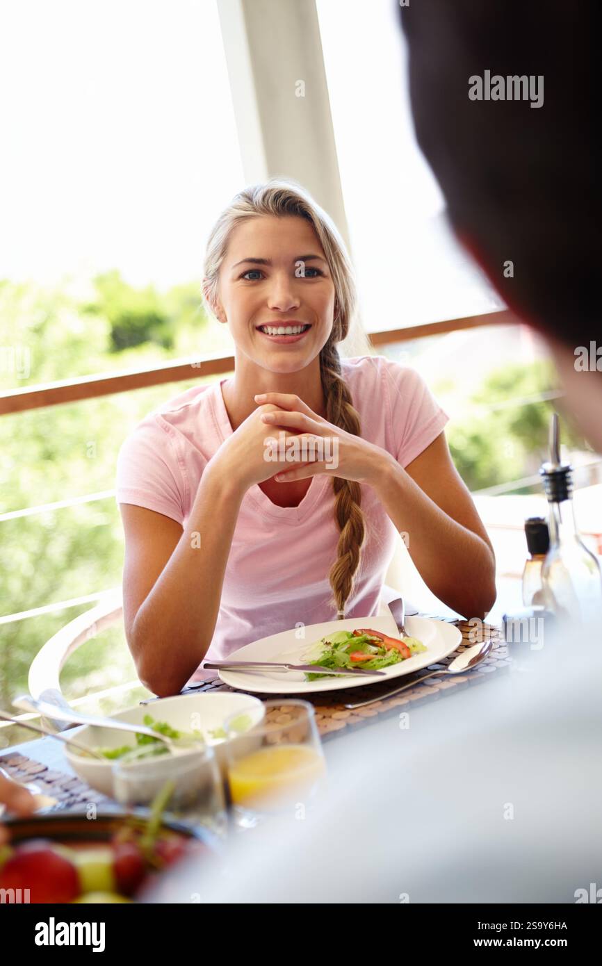 Talking, food and smile with couple at dining table for bonding ...